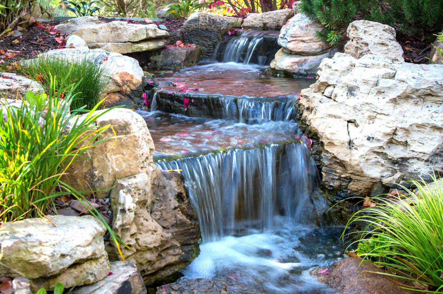 Custom Outdoor Waterfall Installation | A Plus Landscaping